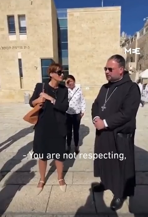 German Priest gets told by an Israeli guard to cover his cross during a ...