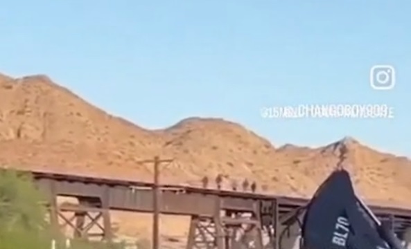 Illegals Jumping the Border get Stuck on a Bridge while a Train is Coming